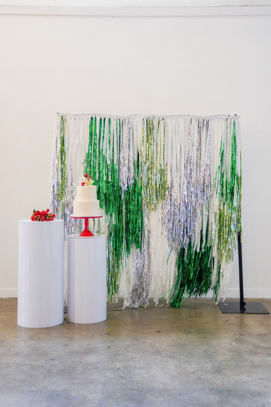 Icy Evergreen Fringe Backdrop exclusive at Oh My Darling Party Co